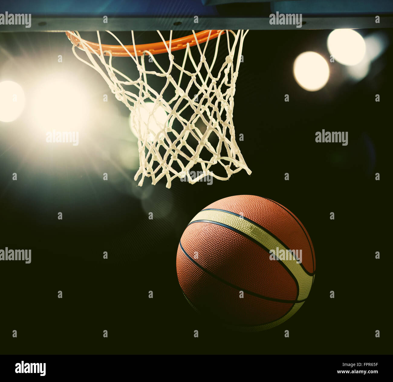 Basketball going through the hoop at a sports arena (intentional ...