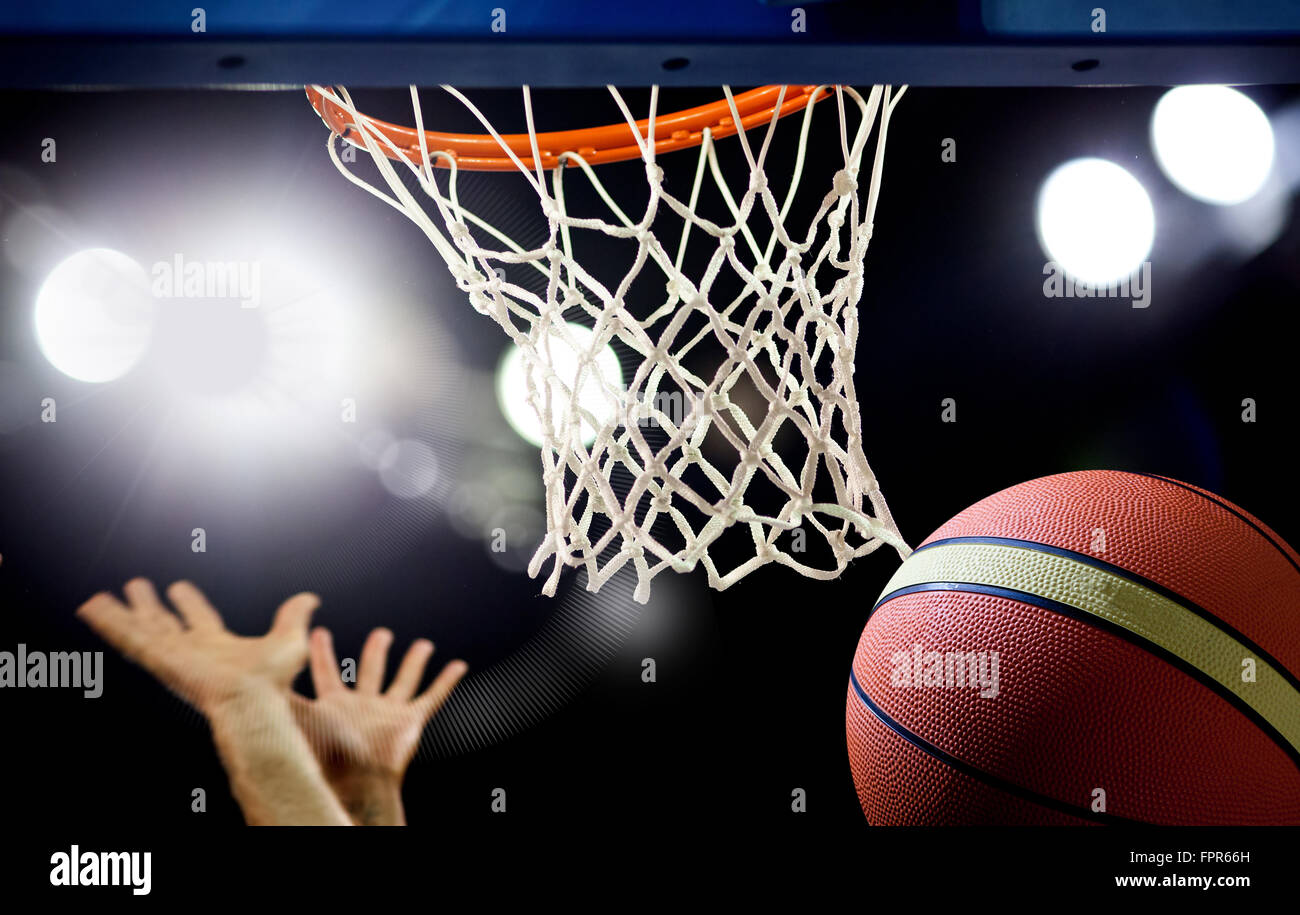 Basketball going through the hoop at a sports arena (intentional ...