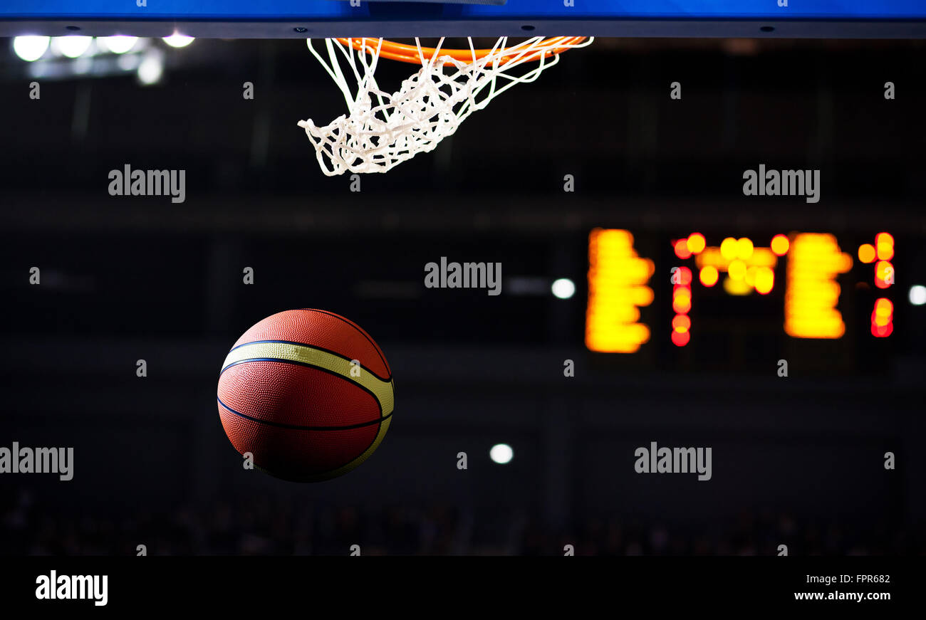 Basketball going through the hoop at a sports arena (intentional ...