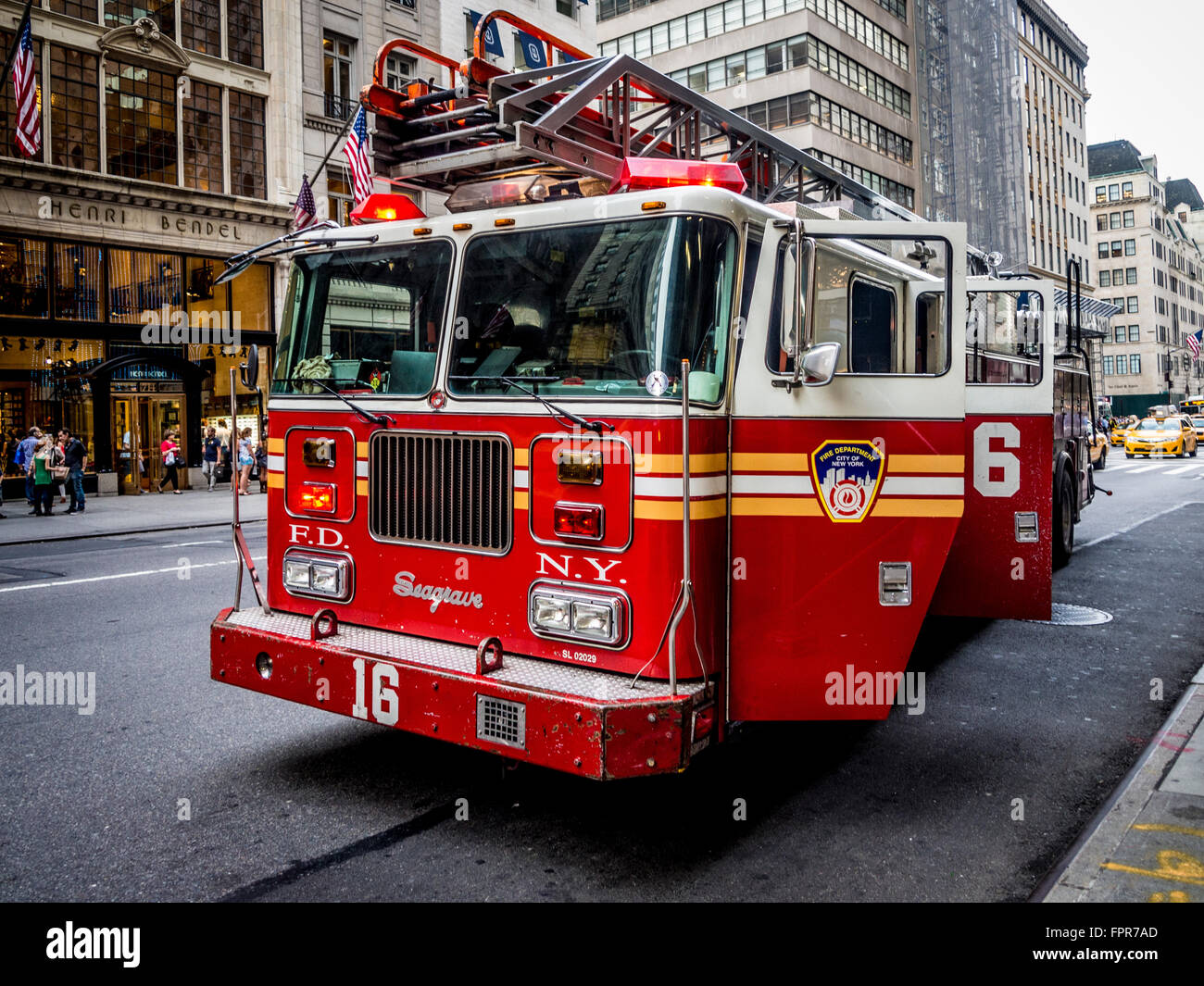 Fire Engine with lights flashing outside building on Fifth Avenue, New ...