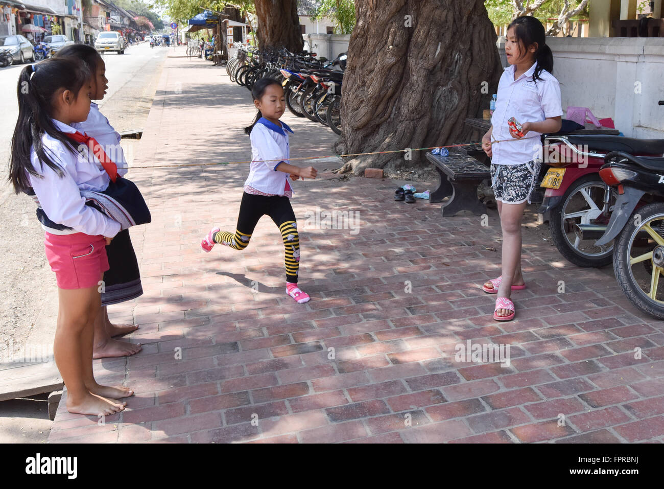 Schoolgirls practicing jumping Luang Prabang Laos Stock Photo - Alamy