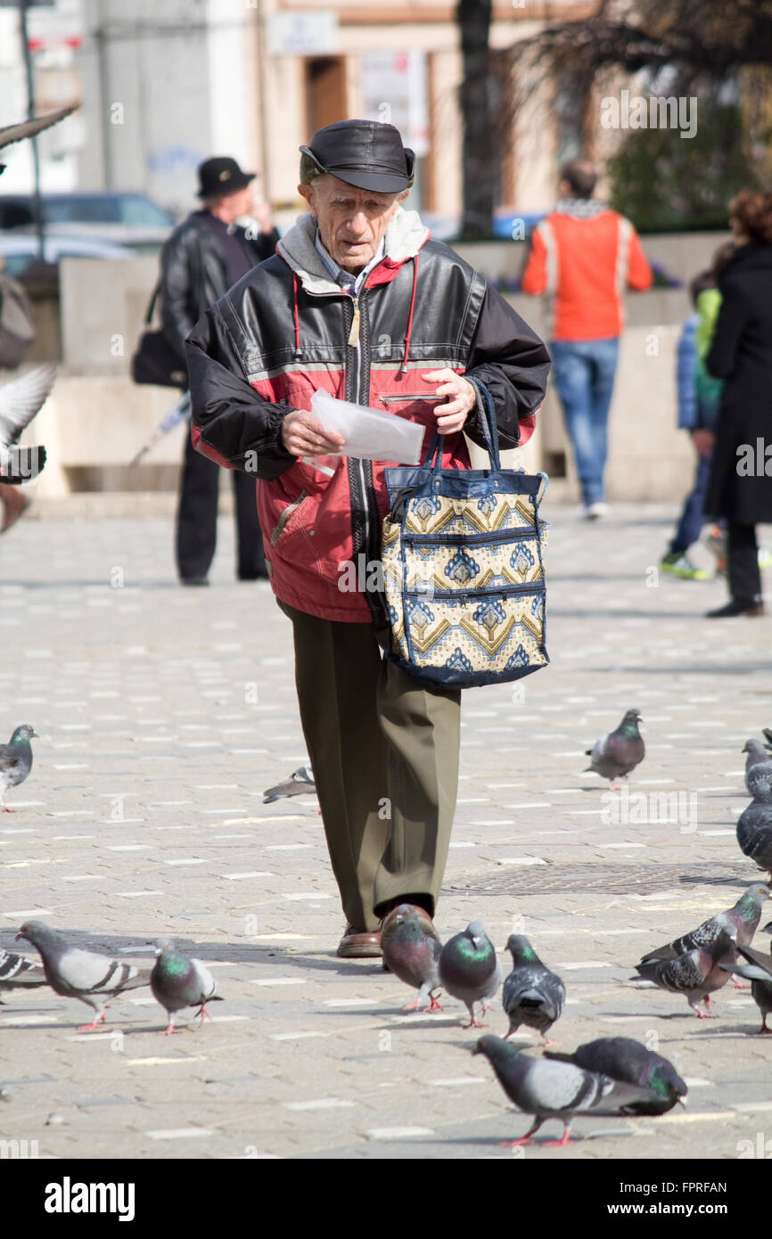 Old man on Victory Square in Timisoara Stock Photo - Alamy