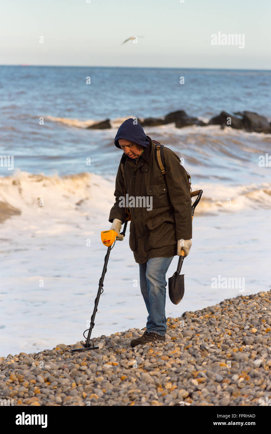 Treasure hunter on beach with metal detector Stock Photo - Alamy
