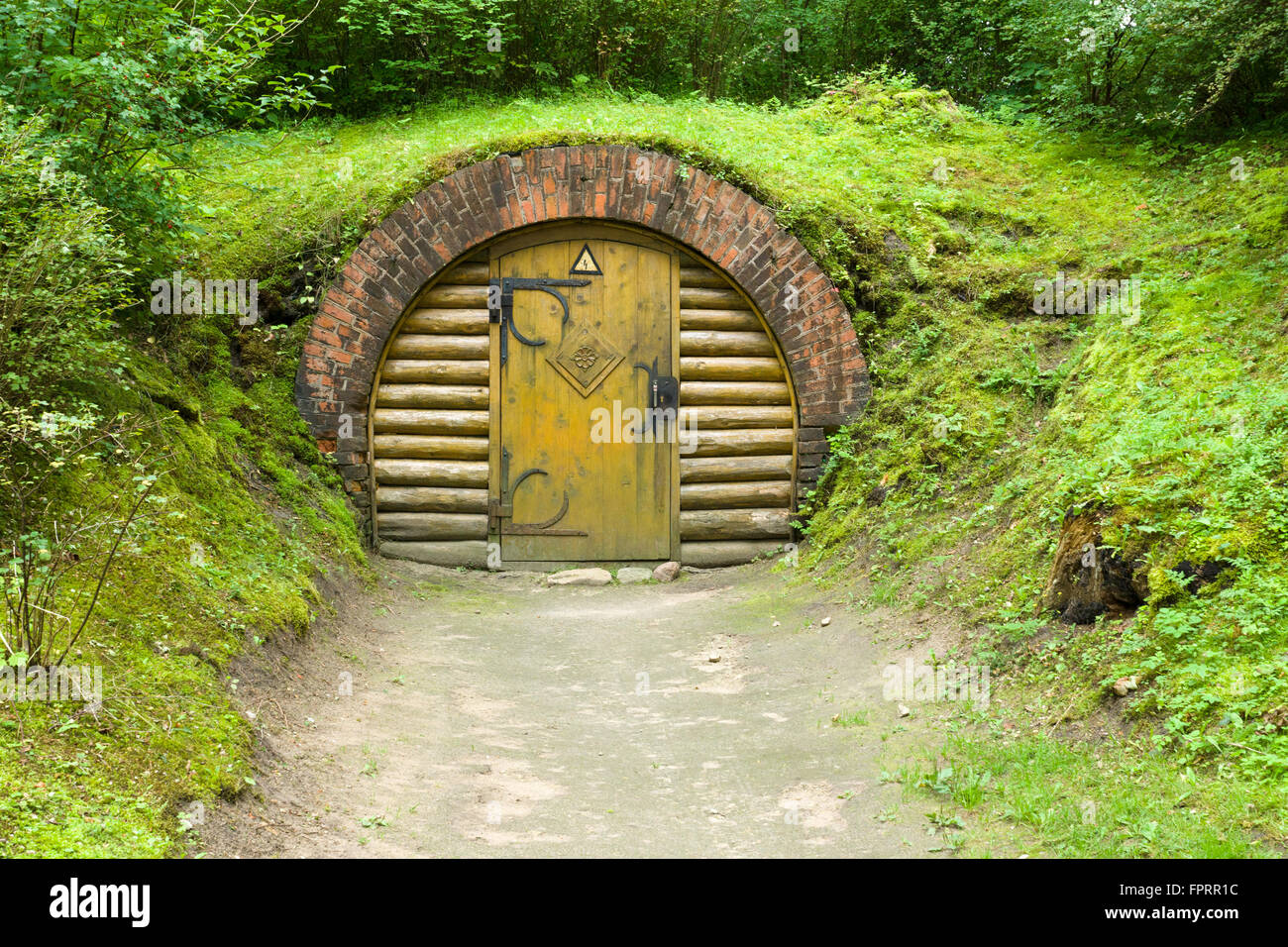 beautiful wooden door leading in an underground structure Stock Photo ...