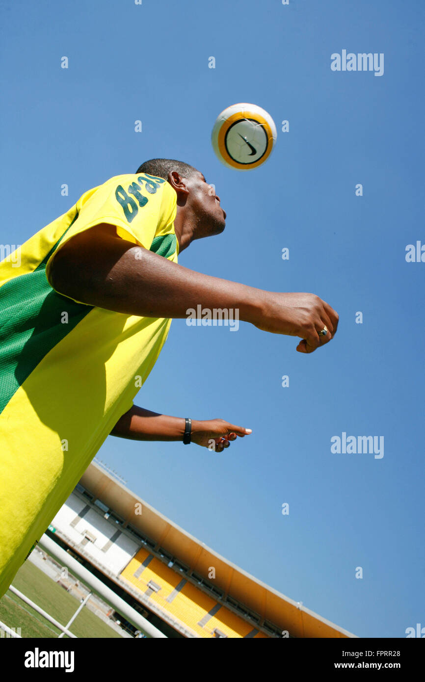 A Brazilian man heading a football Stock Photo - Alamy