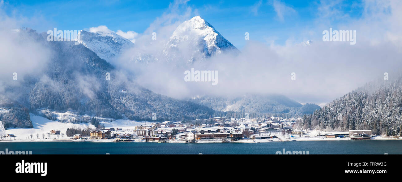 Pertisau in winter with clouds, behind Rofan mountains with Feilkopf ...