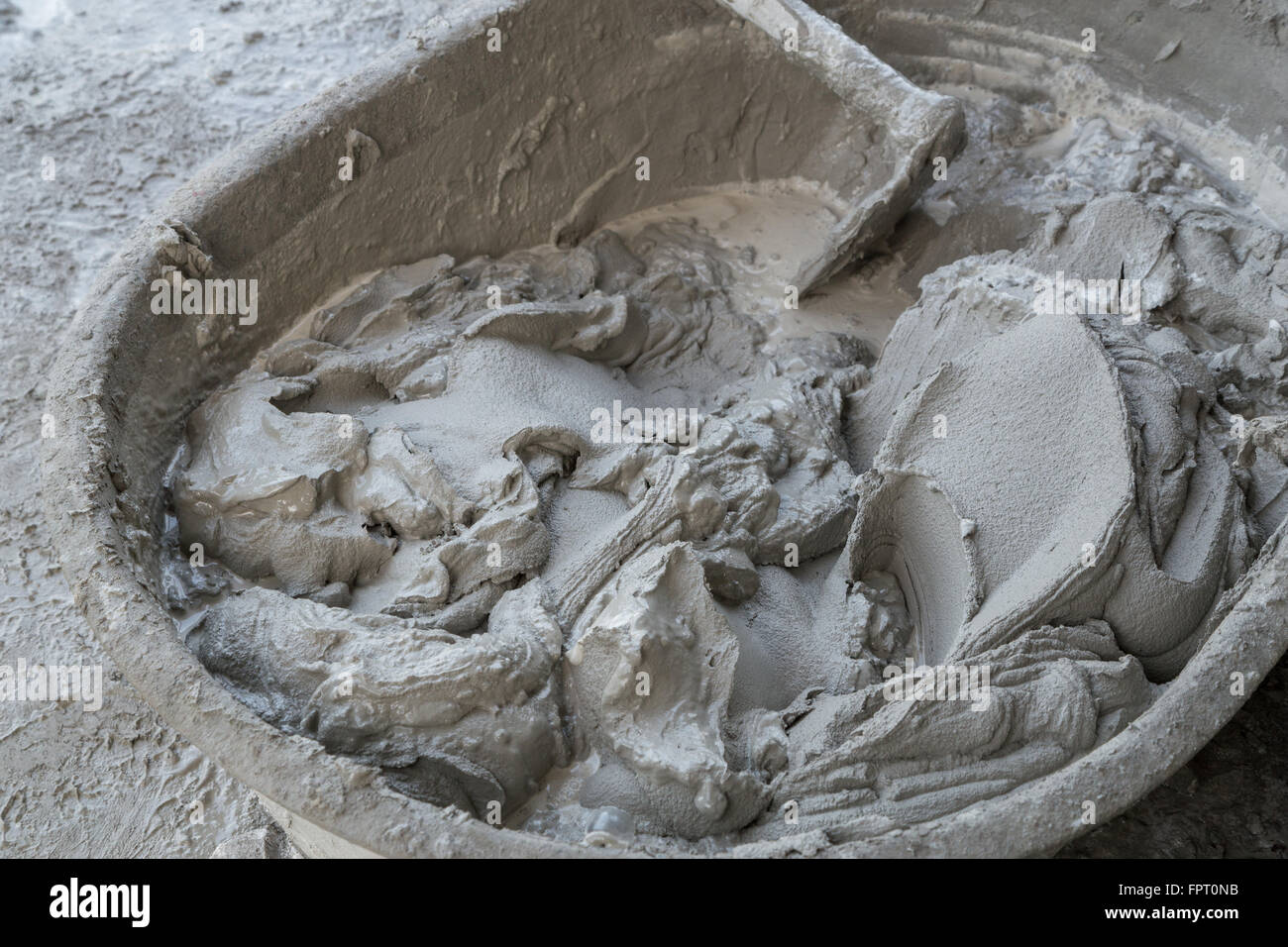 Mixing a cement in salver for applying construction Stock Photo - Alamy