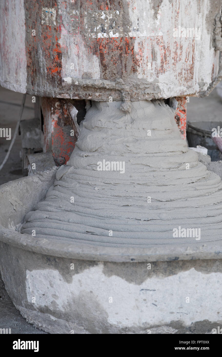 pouring cement or mortar from cement mixer to salver for applying ...