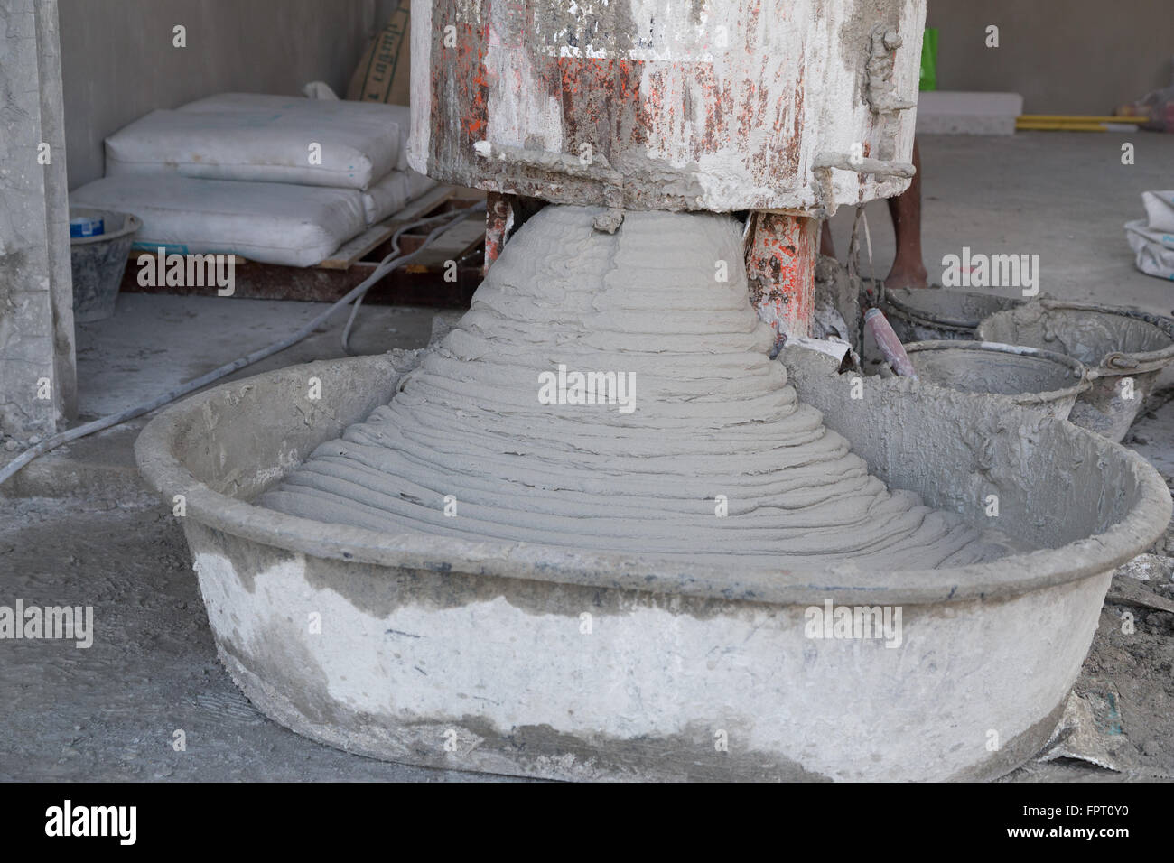 pouring cement or mortar from cement mixer to salver for applying ...