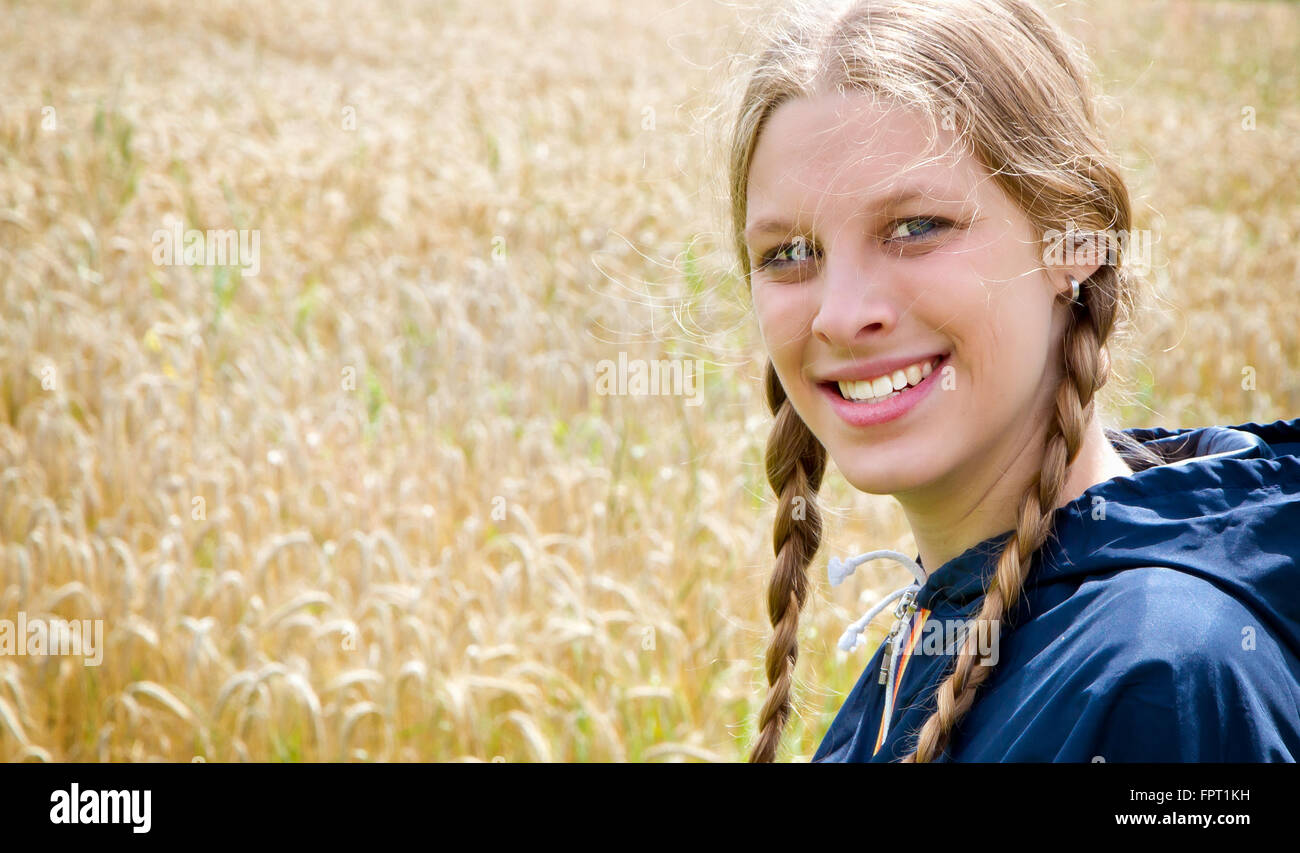 Farm girl in a wheat field Stock Photo - Alamy