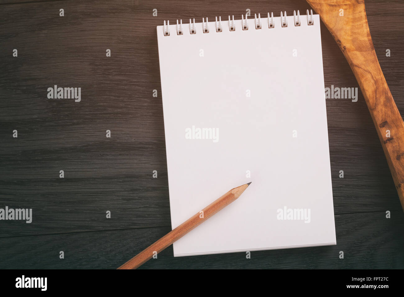 notepad with pencil and wood utensils on wood table Stock Photo - Alamy