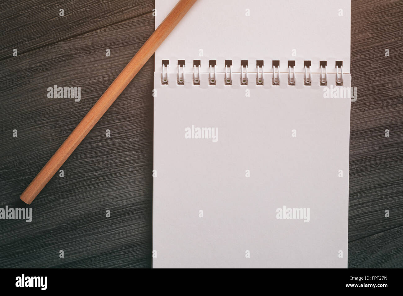 notepad with pencil on wood table Stock Photo - Alamy