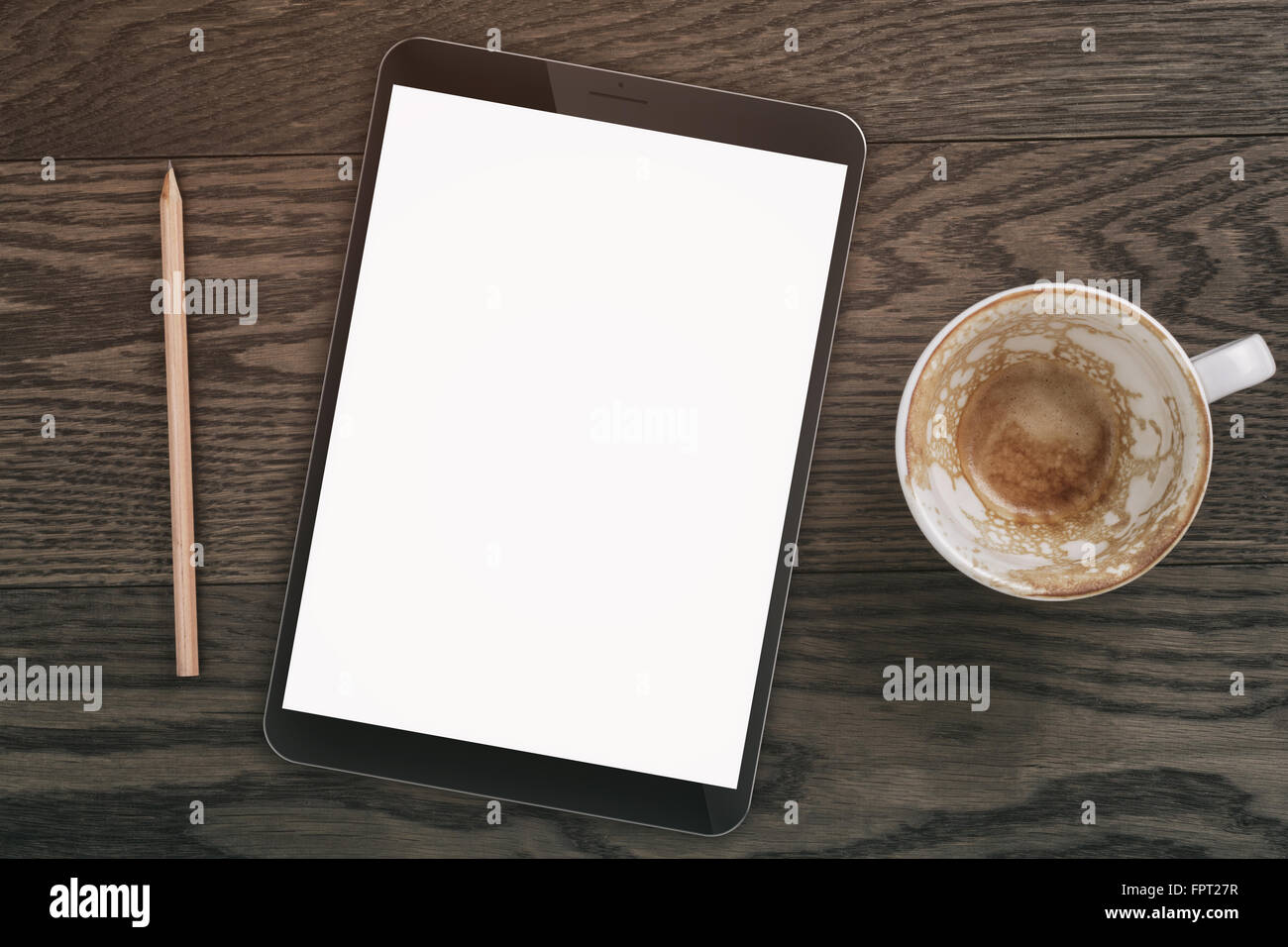 generic tablet pc with blank screen on wood table with empty coffee cup ...