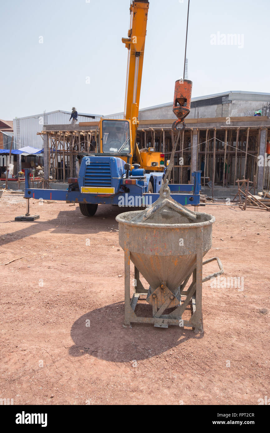Crane lifting concrete mixer container at construction site Stock Photo ...