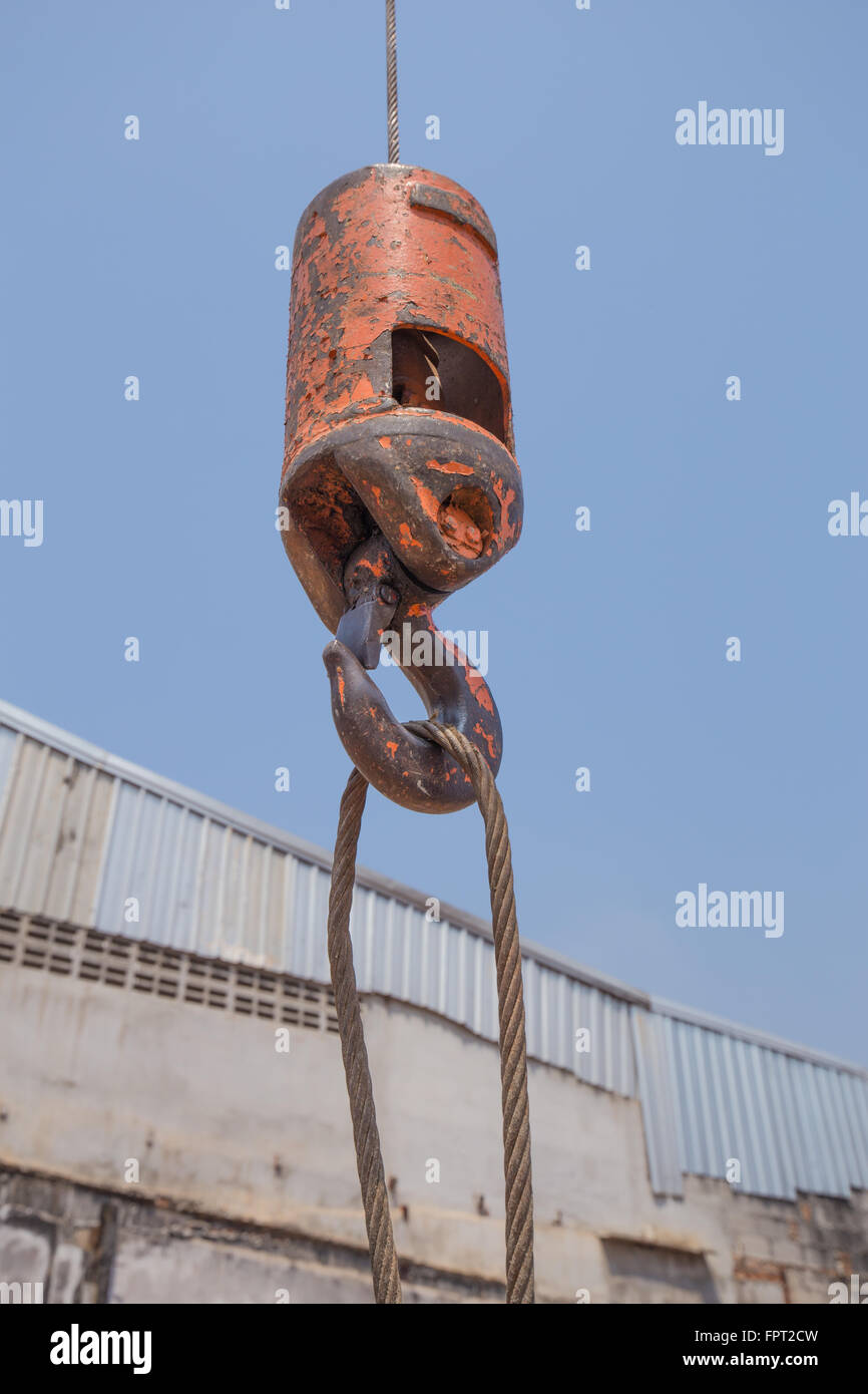 ranes hooks hanging on steel ropes with sky background Stock Photo - Alamy