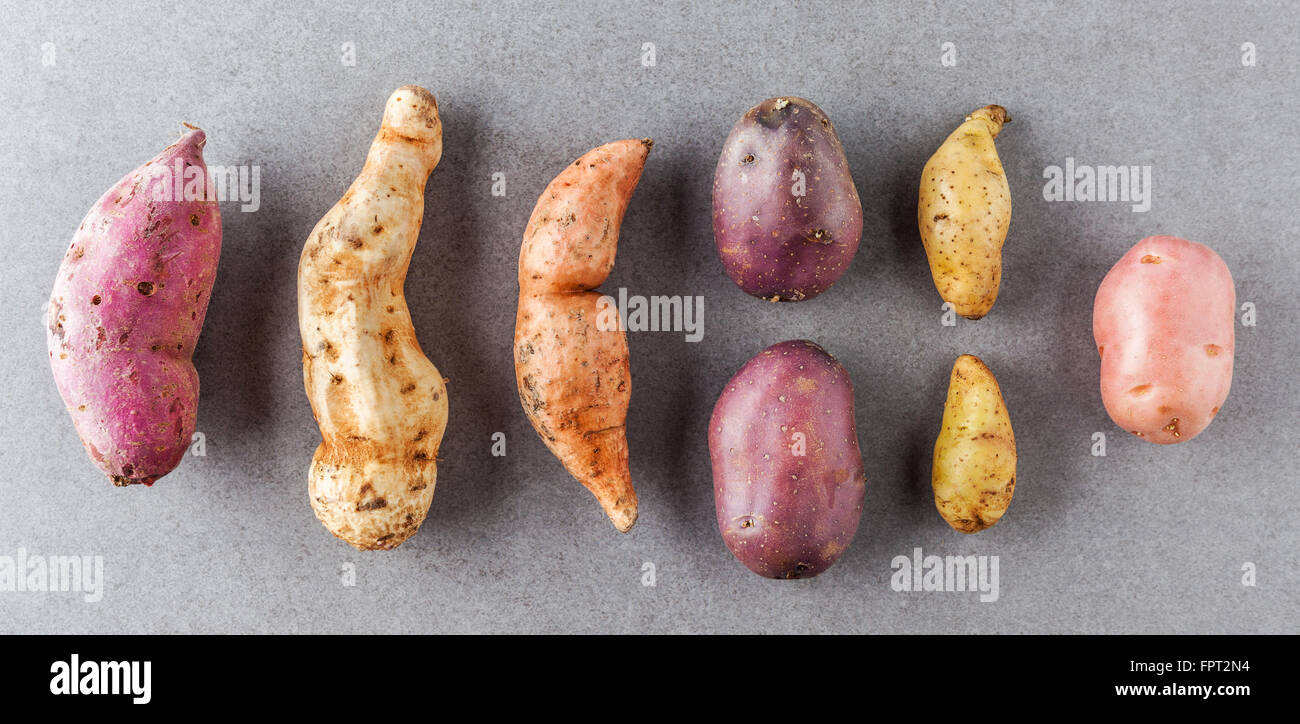 Different kinds of potatoes flat lay on stone surface Stock Photo - Alamy