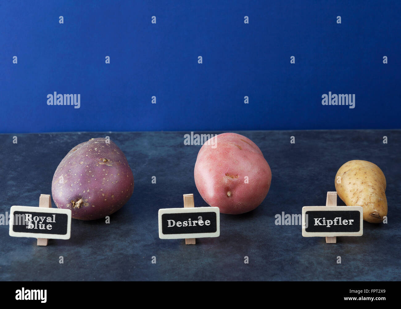 Three kinds of potatoes with blue background and copy space Stock Photo ...