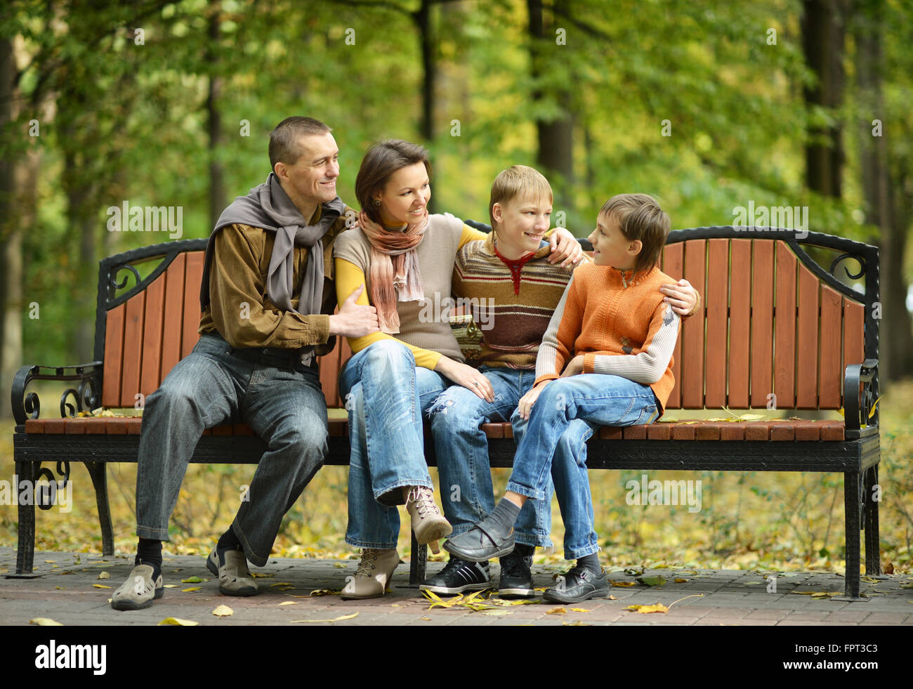 Family of four sitting Stock Photo - Alamy