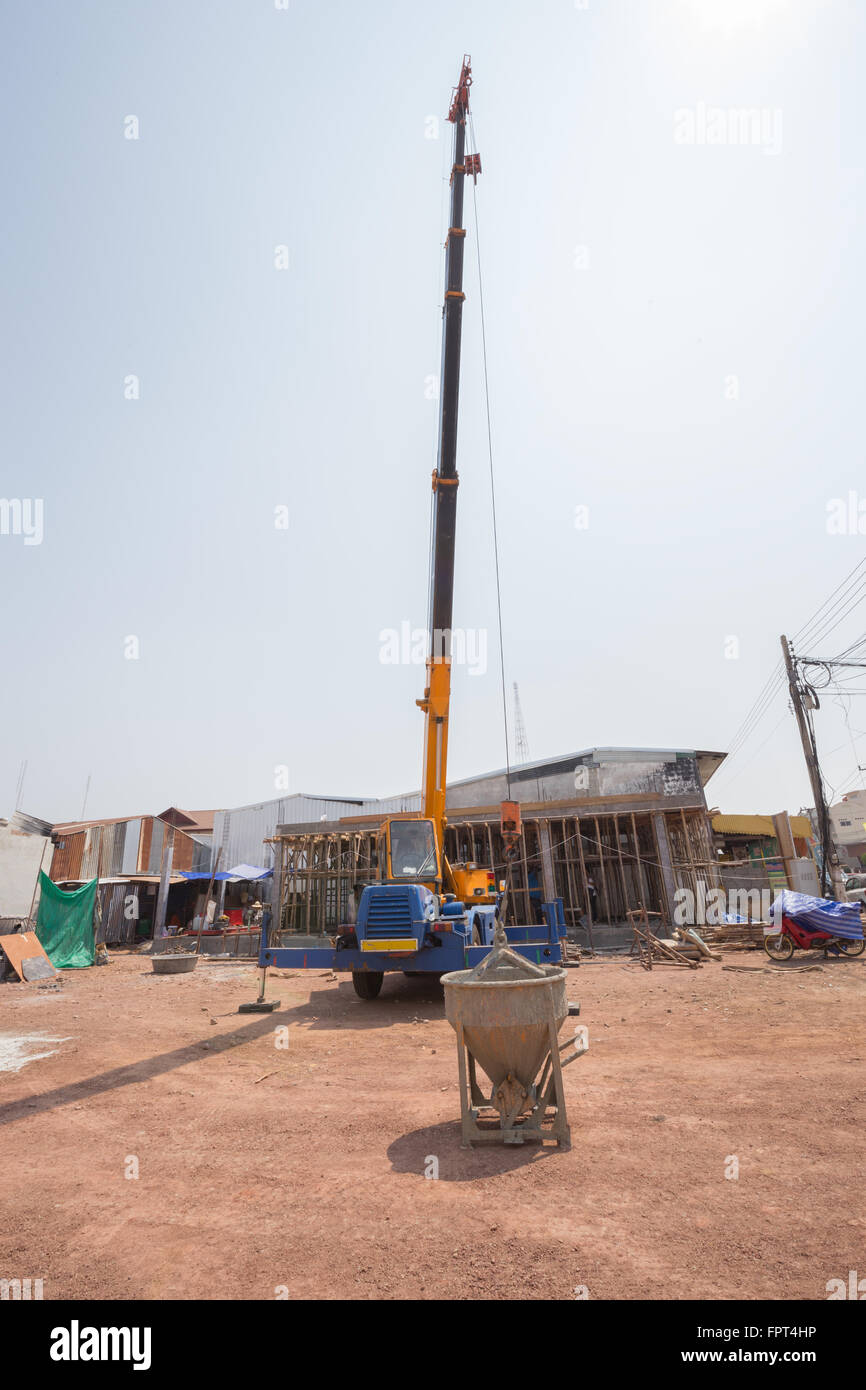 Crane lifting concrete mixer container at construction site Stock Photo ...