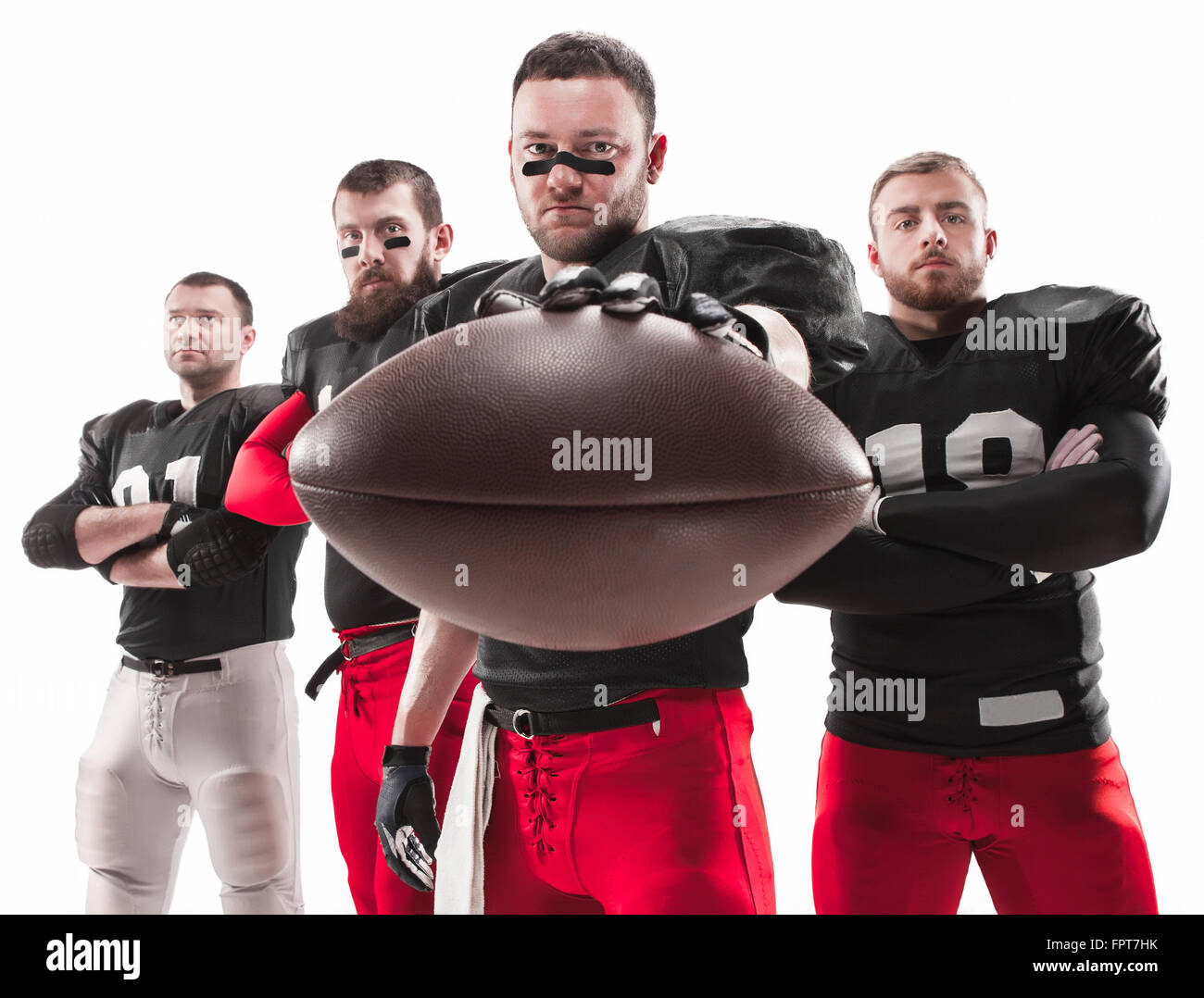 The four caucasian fitness men as american football players posing full ...