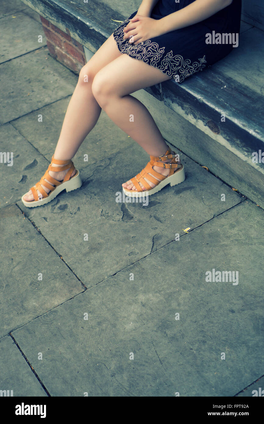 Woman sat on the bench outdoors Stock Photo - Alamy