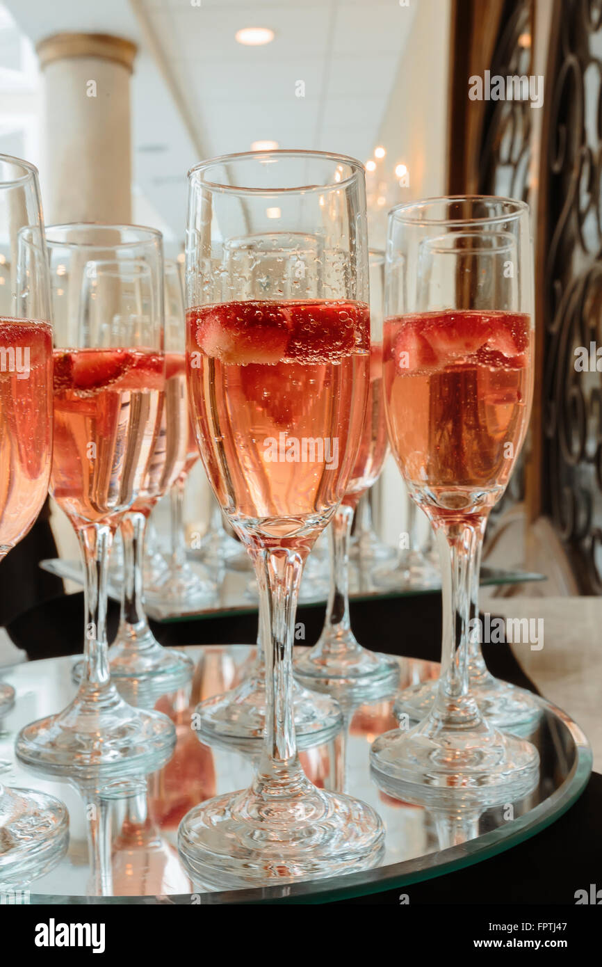 Festive champagne flutes filled with sparkling wine and floating ...