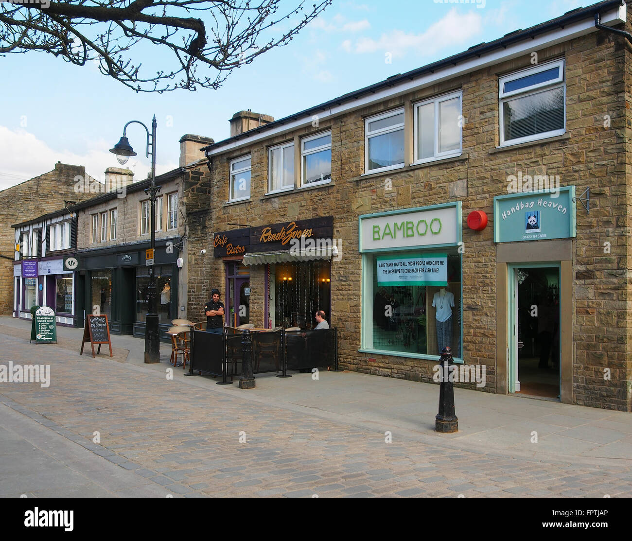 Row of shops and cafes in Hebden Bridge, Yorkshire, a small town which ...
