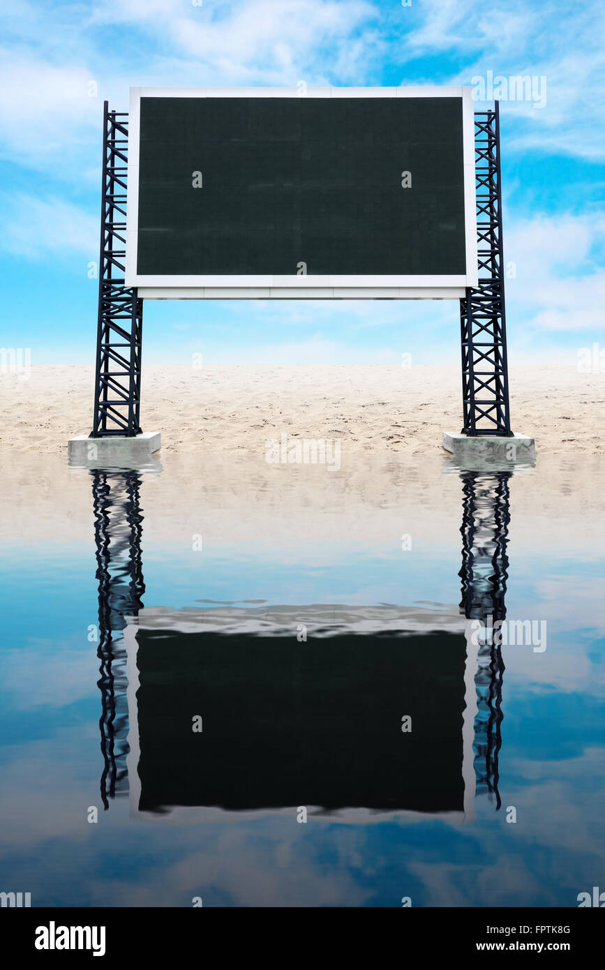 large empty sign board on sand with water reflection and blue sky ...