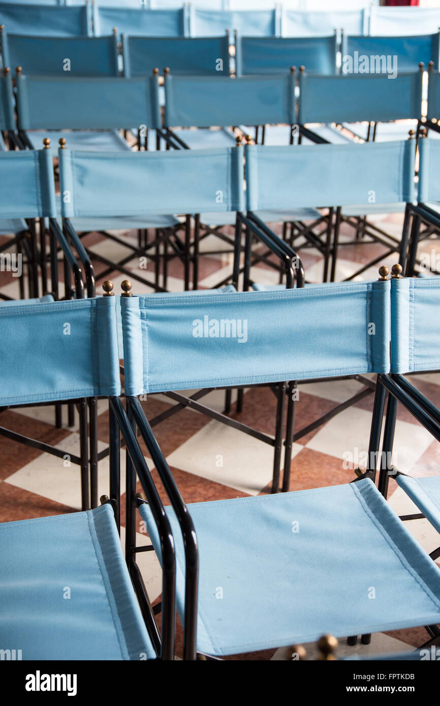 composition of blue canvas folding chairs empty Stock Photo - Alamy
