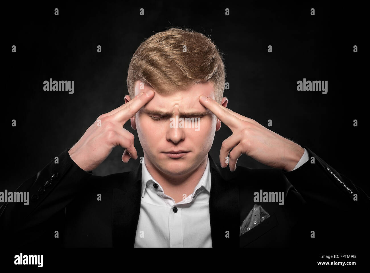 Man feeling a headache or intensely thinking Stock Photo - Alamy