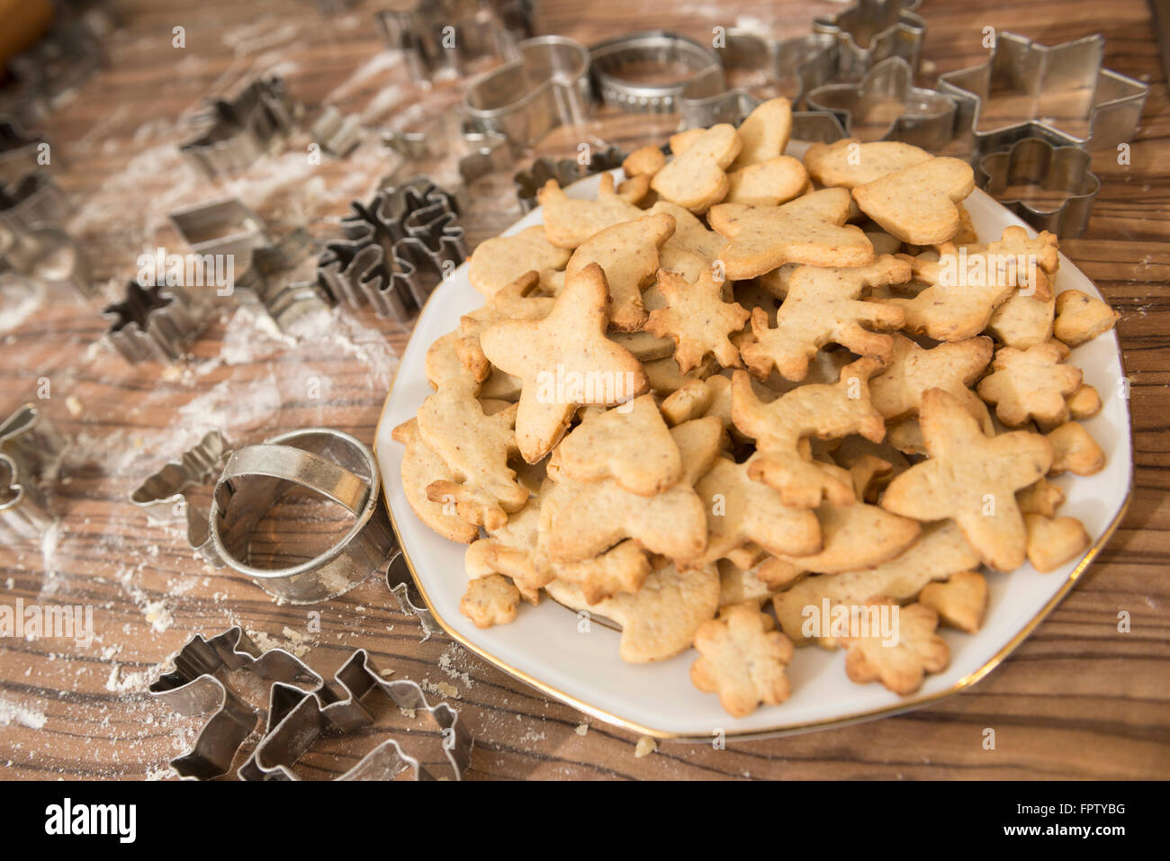 Variety of christmas cookies and pastry cutter on kitchen counter ...