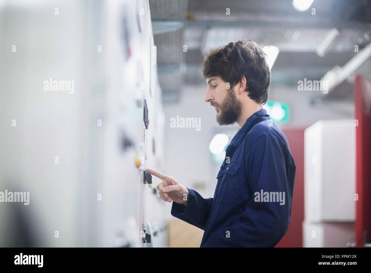 Young male engineer controlling a switch gear in control room, Freiburg ...