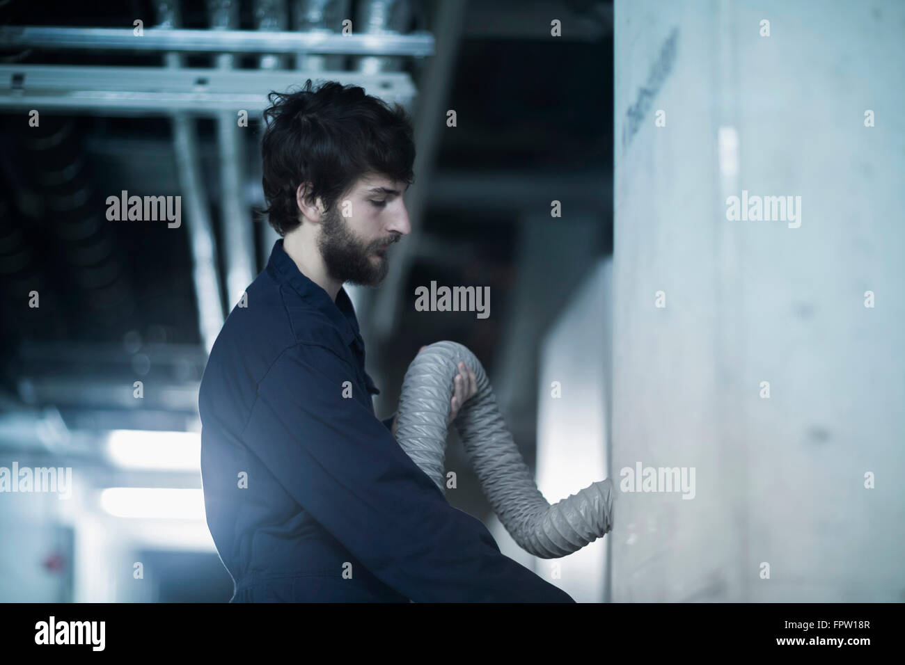Man holding hose pipe hi-res stock photography and images - Alamy