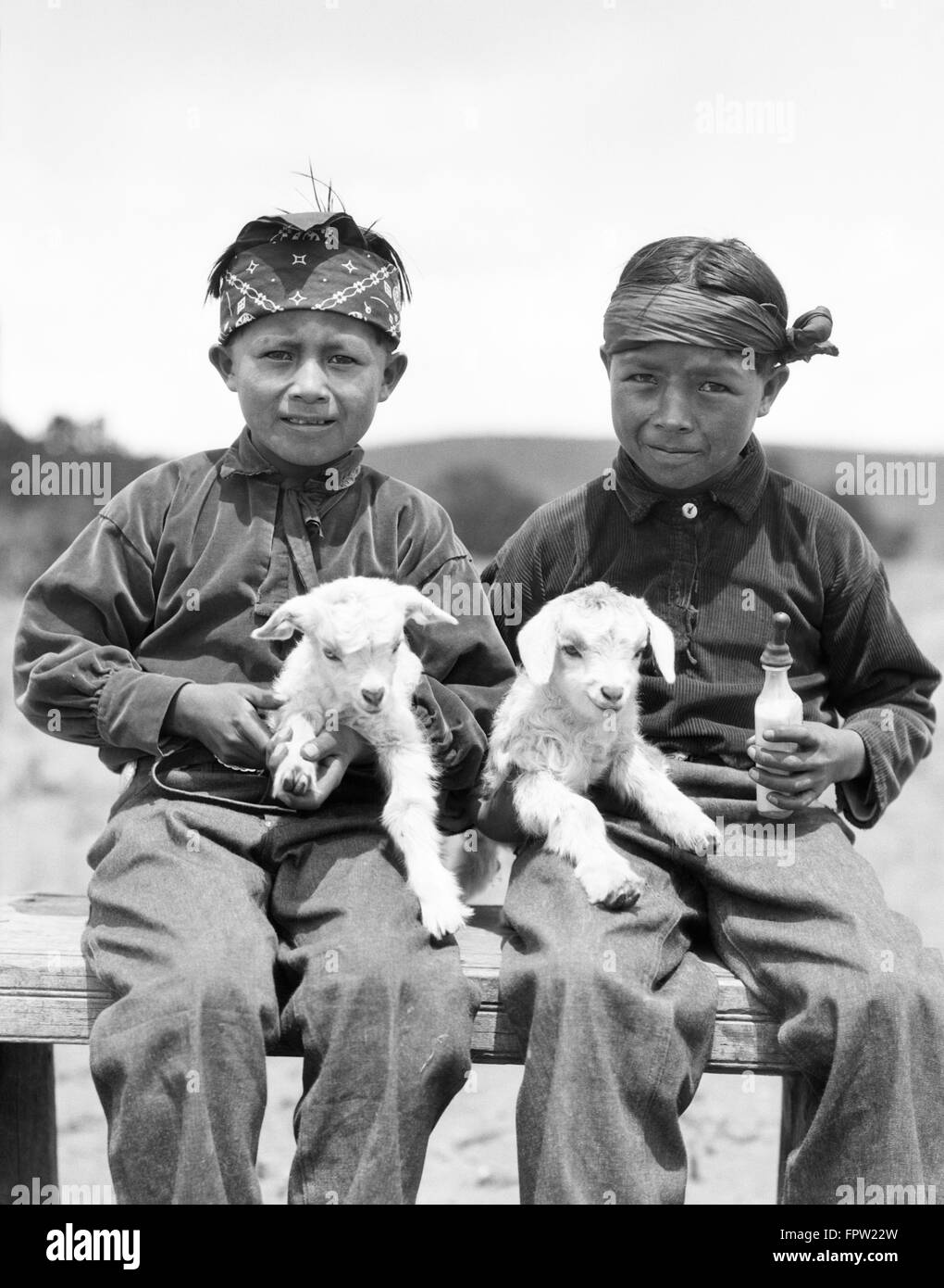 1930s TWO NATIVE AMERICAN NAVAJO BOYS LOOKING AT CAMERA HOLDING TWO ...