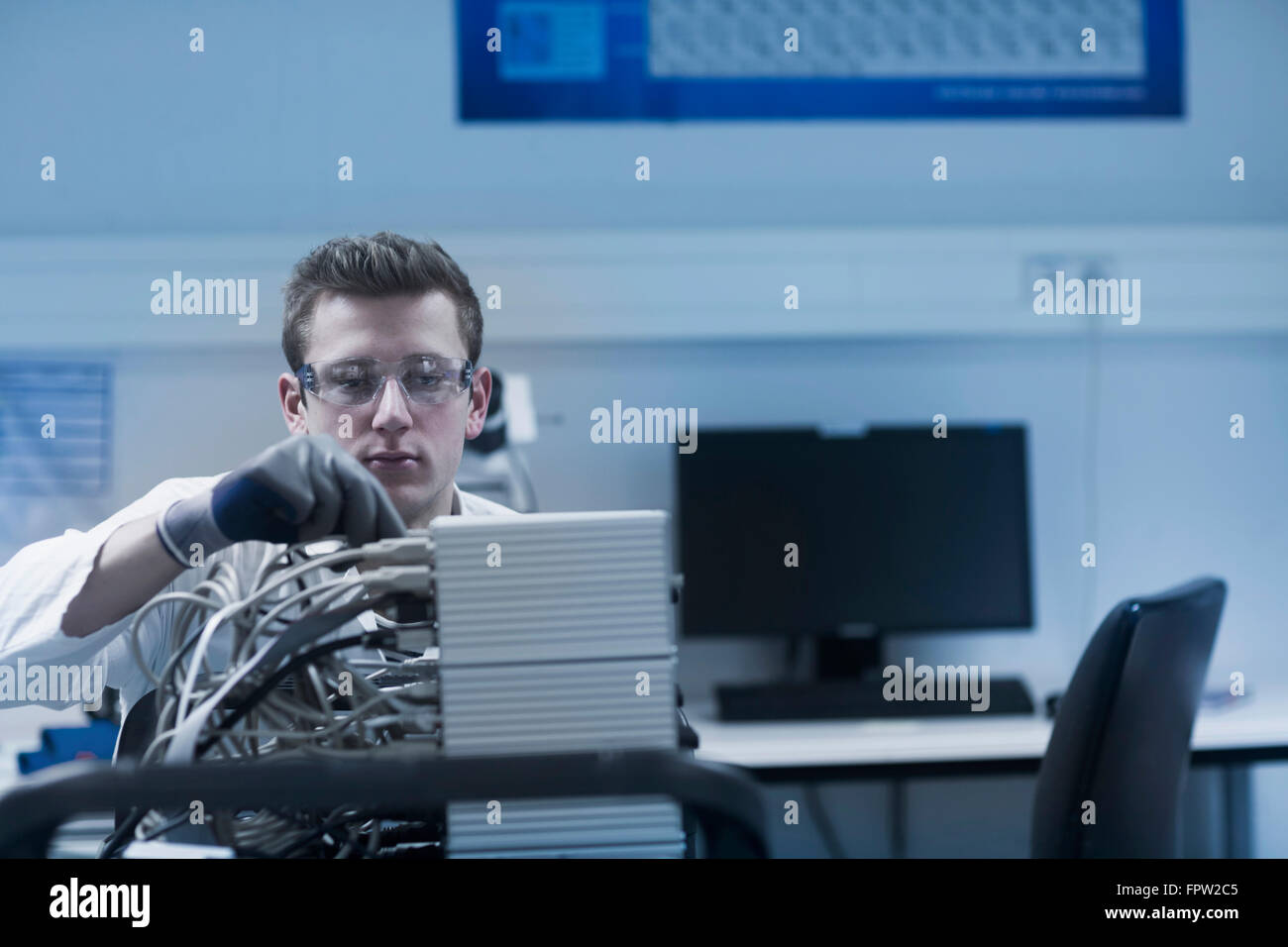 Young male scientist working in an optical laboratory, Freiburg Im ...