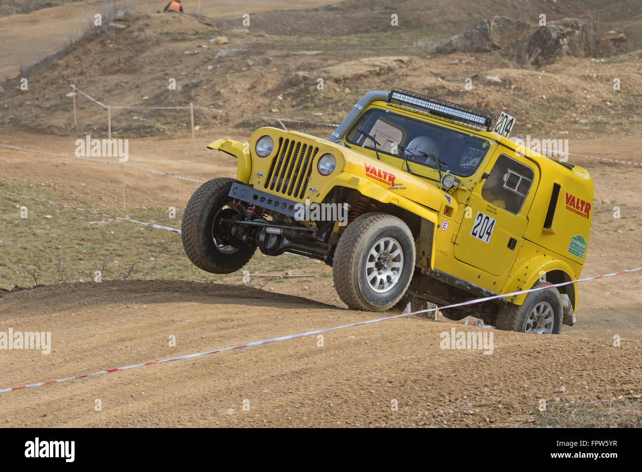 Yellow off road car is jumping in terrain Stock Photo - Alamy