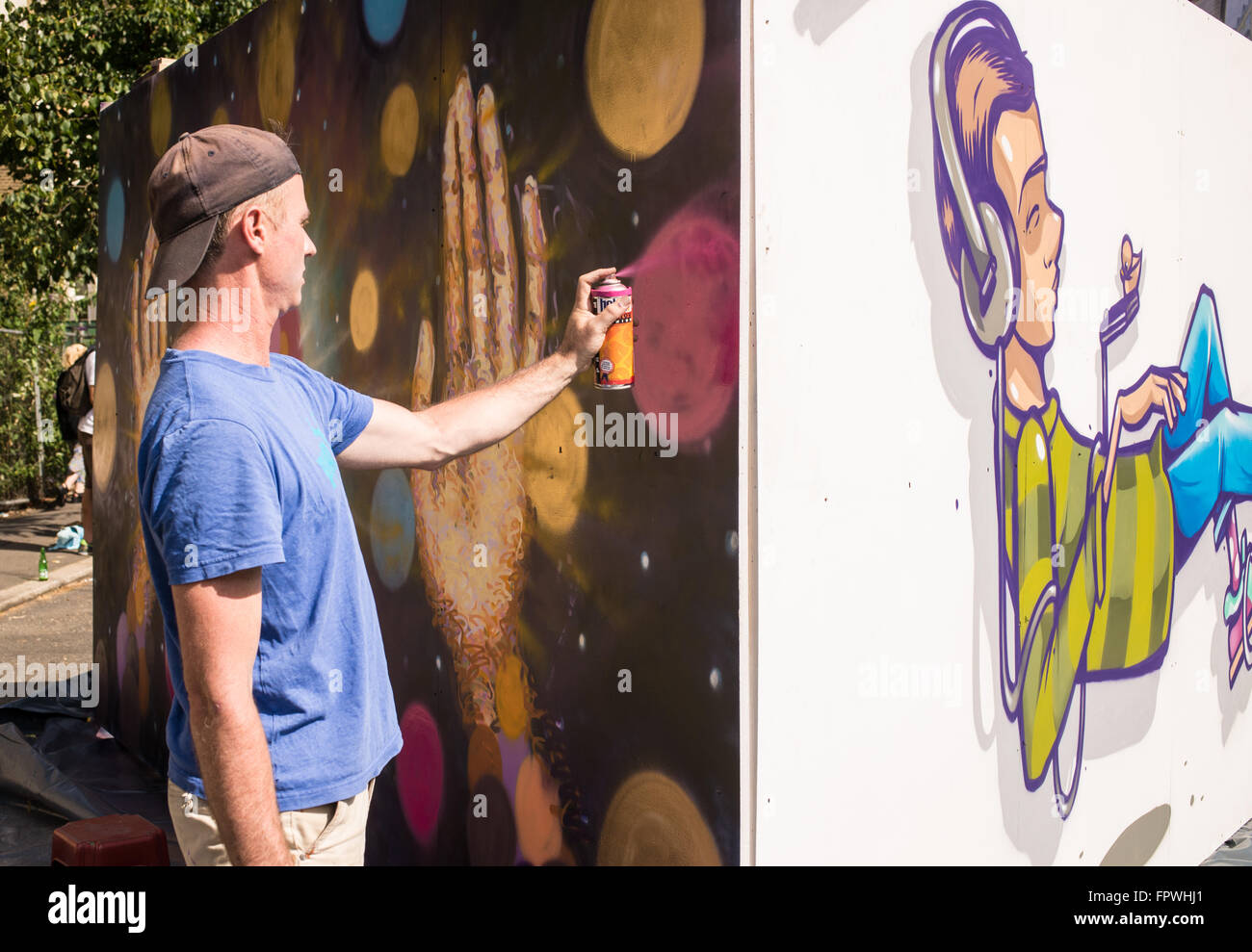 Writer painting a new graffiti with a spray. The new graffiti was ...
