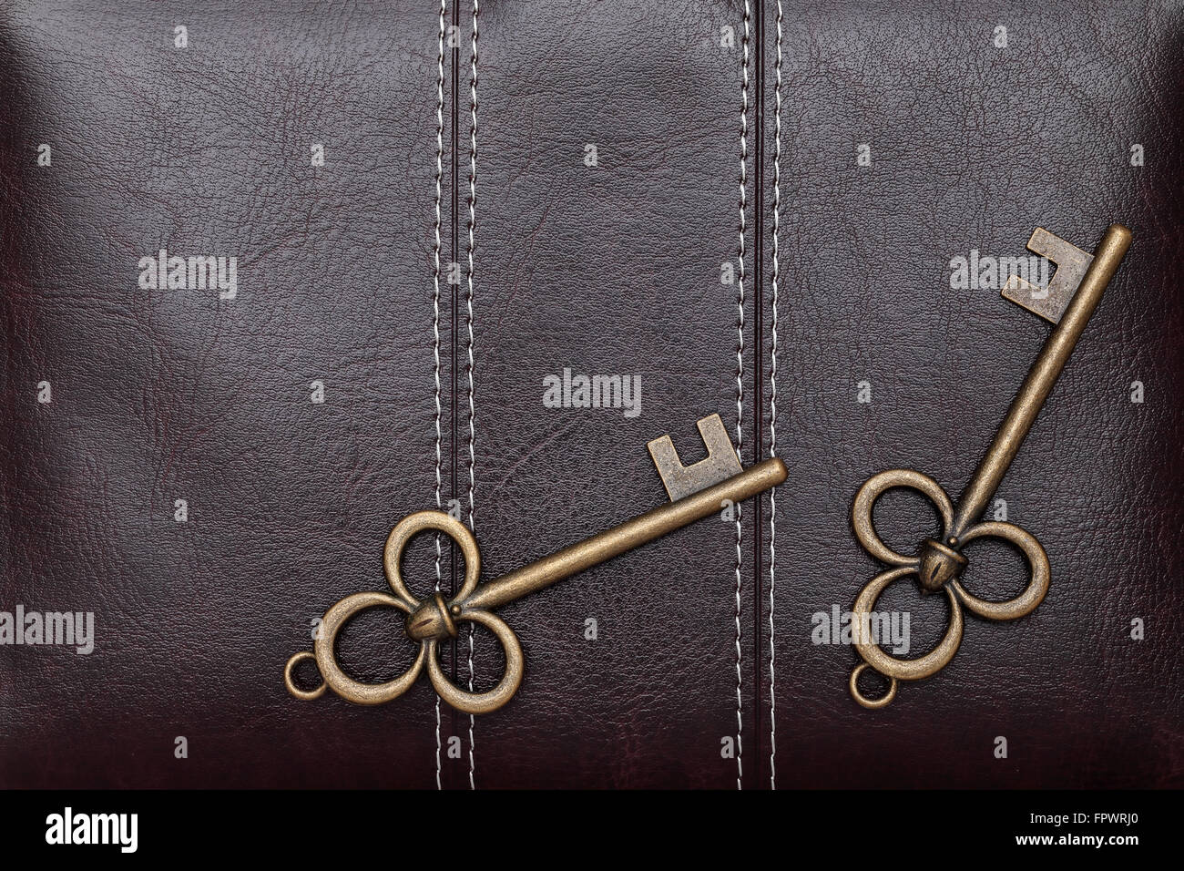 Antique key on brown leather background Stock Photo - Alamy