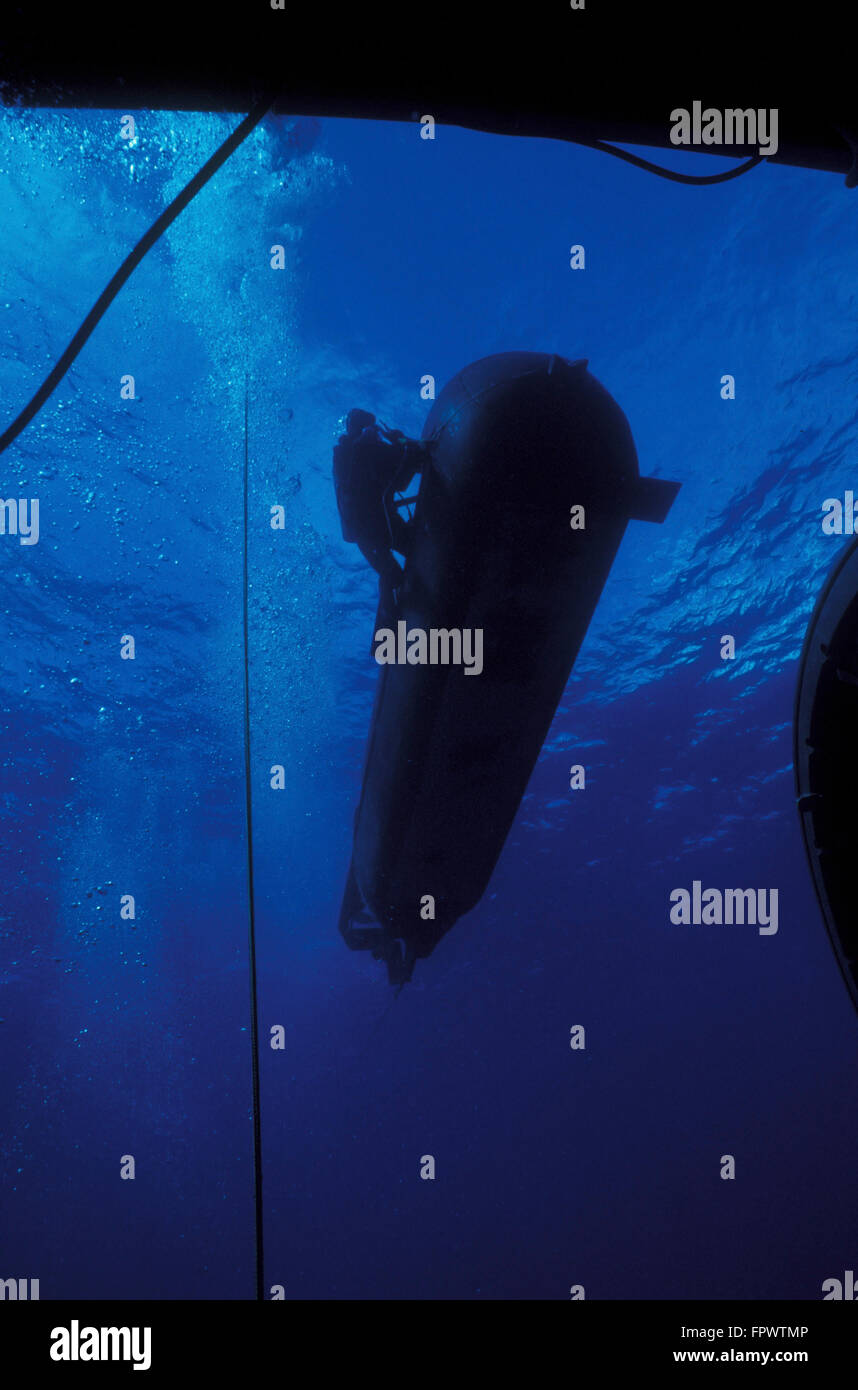 SEAL Delivery Vehicle (SDV) navigator leans out of the SDV to grab the ...