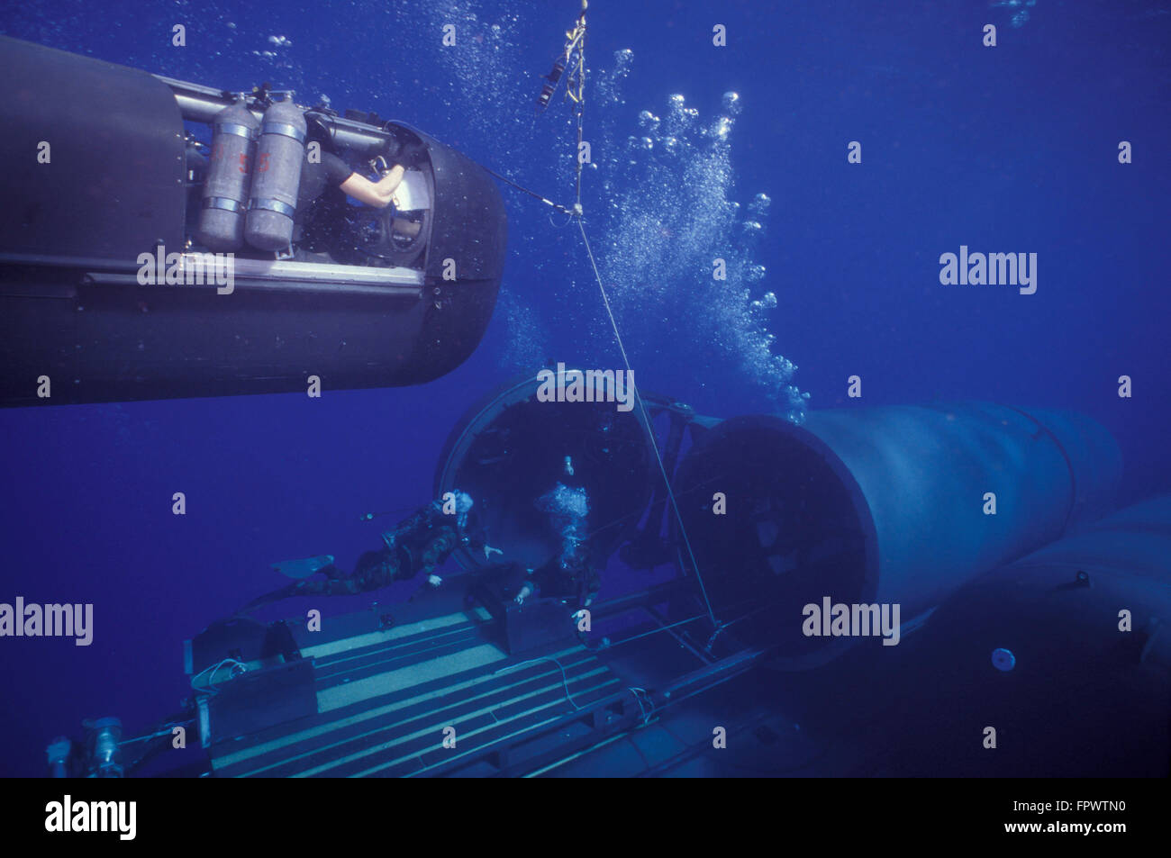 SEAL Delivery Vehicle (SDV) hovers in mid-water on tether to the Dry ...