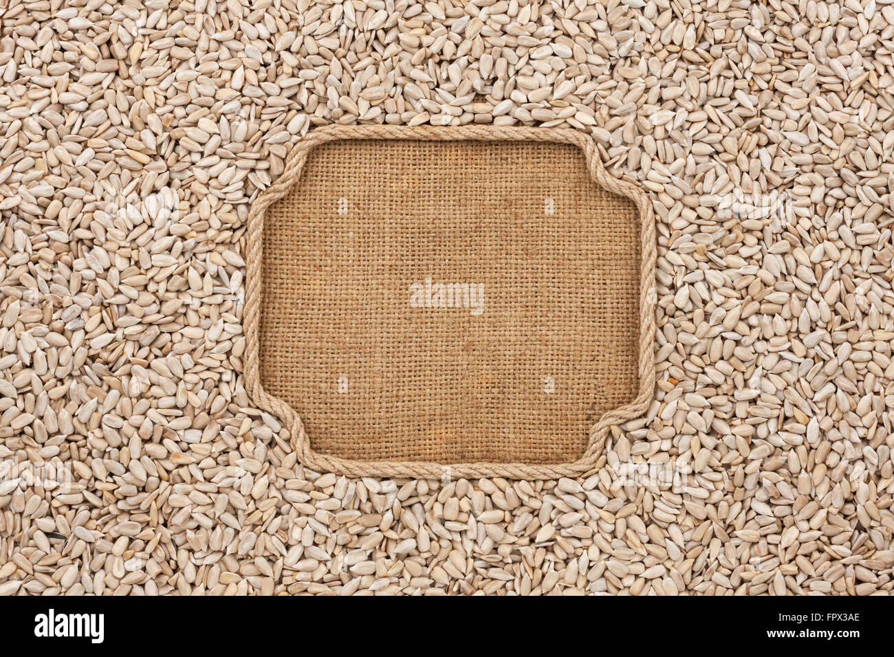 Figured frame made of rope with sunflower seeds on sackcloth, with ...