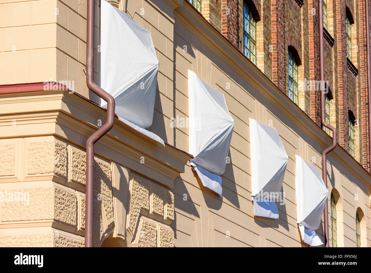 A temporary weather seal cover the windows on a building as the windows ...