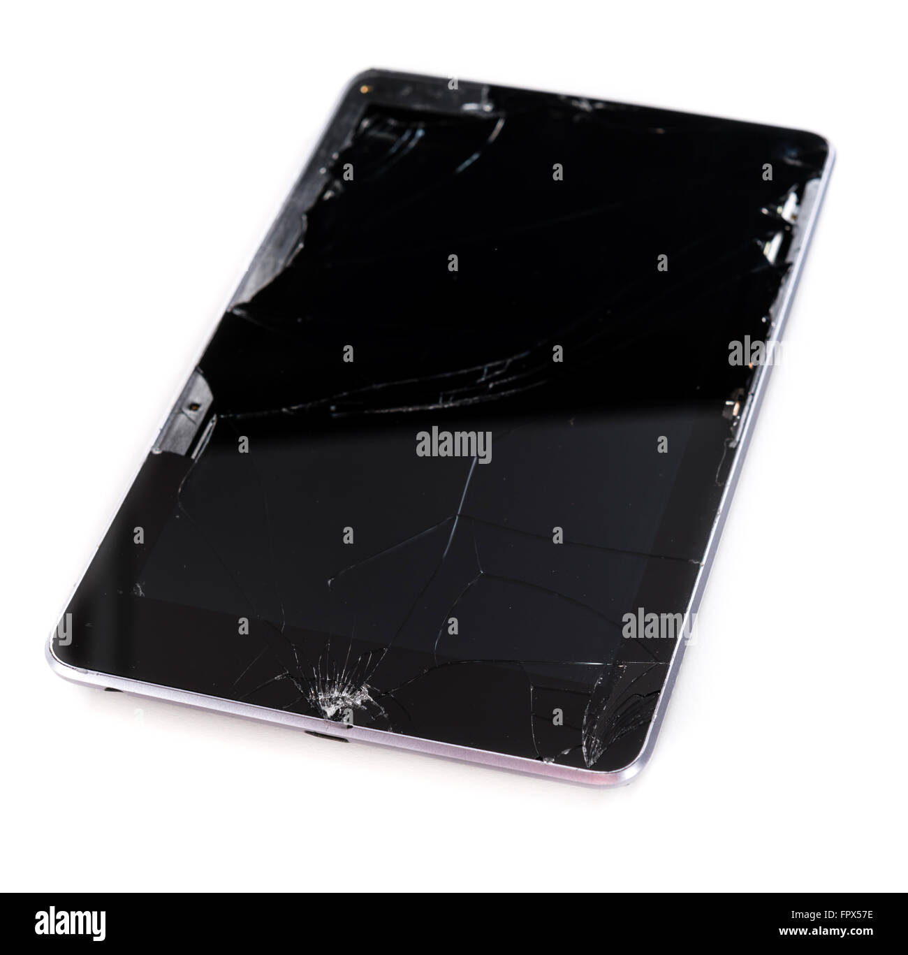 A broken tablet computer as detailed close-up shot on neutral white ...