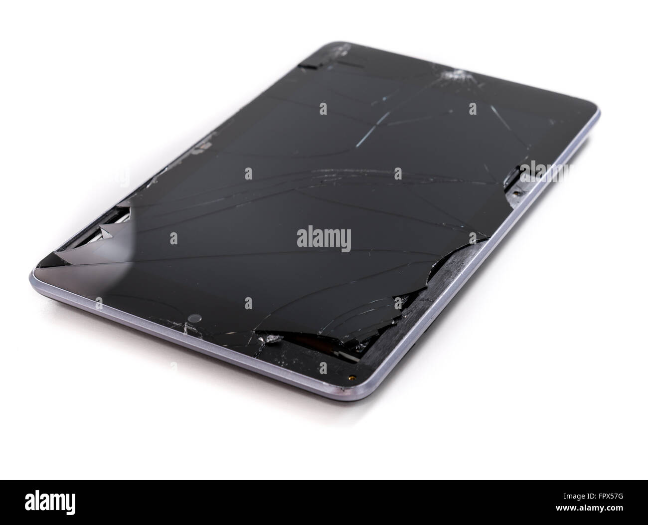 A broken tablet computer as detailed close-up shot on neutral white ...