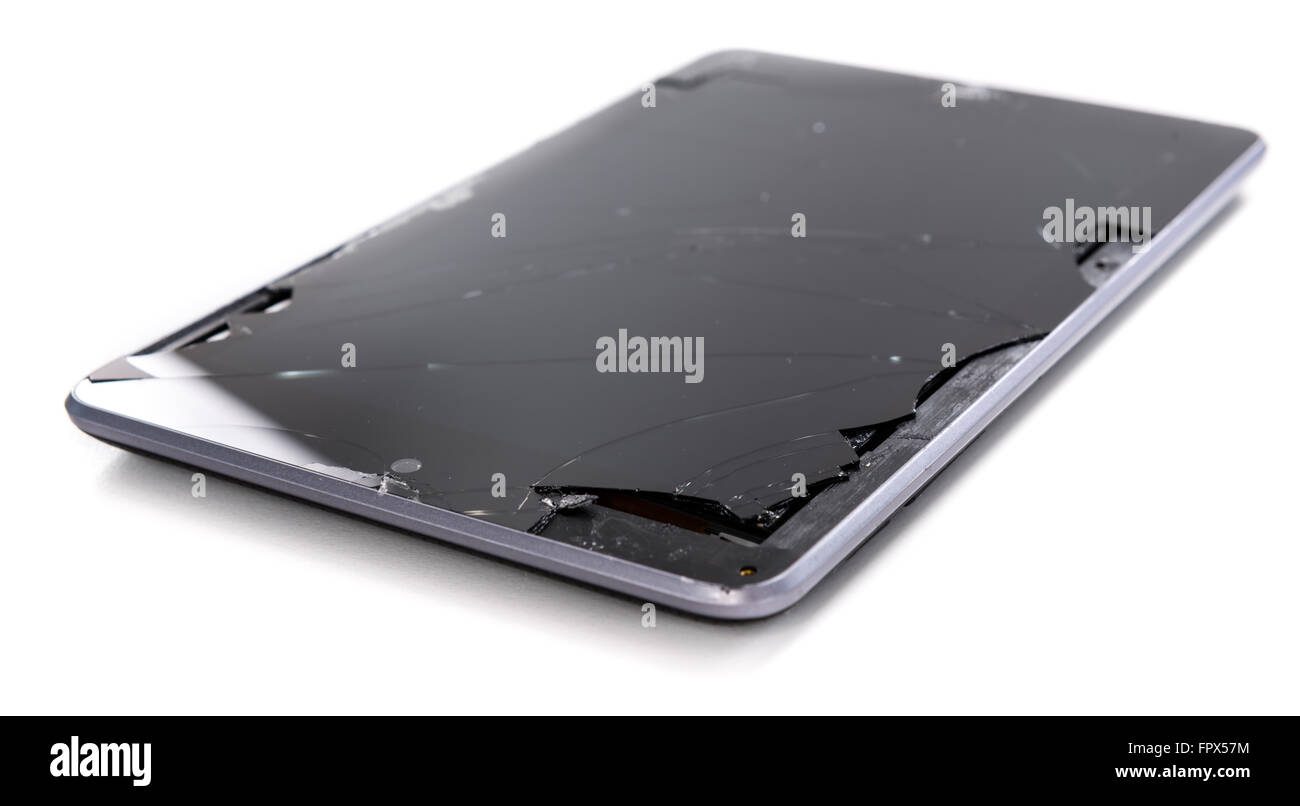 A broken tablet computer as detailed close-up shot on neutral white ...