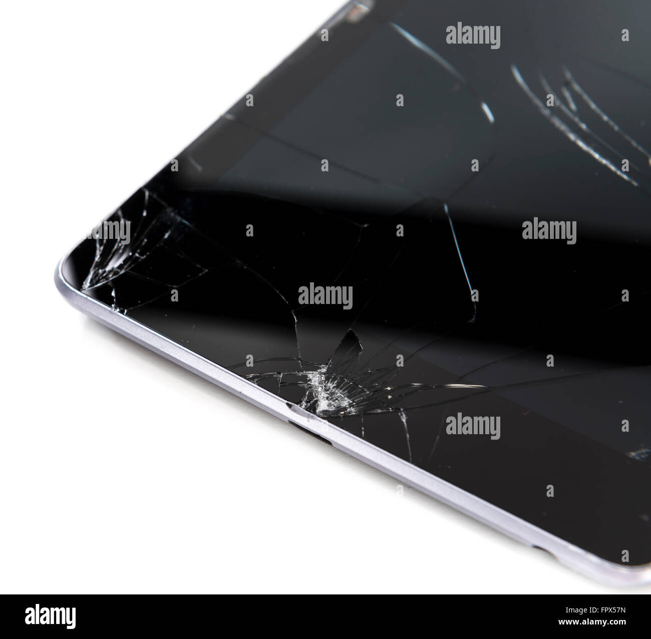 A broken tablet computer as detailed close-up shot on neutral white ...