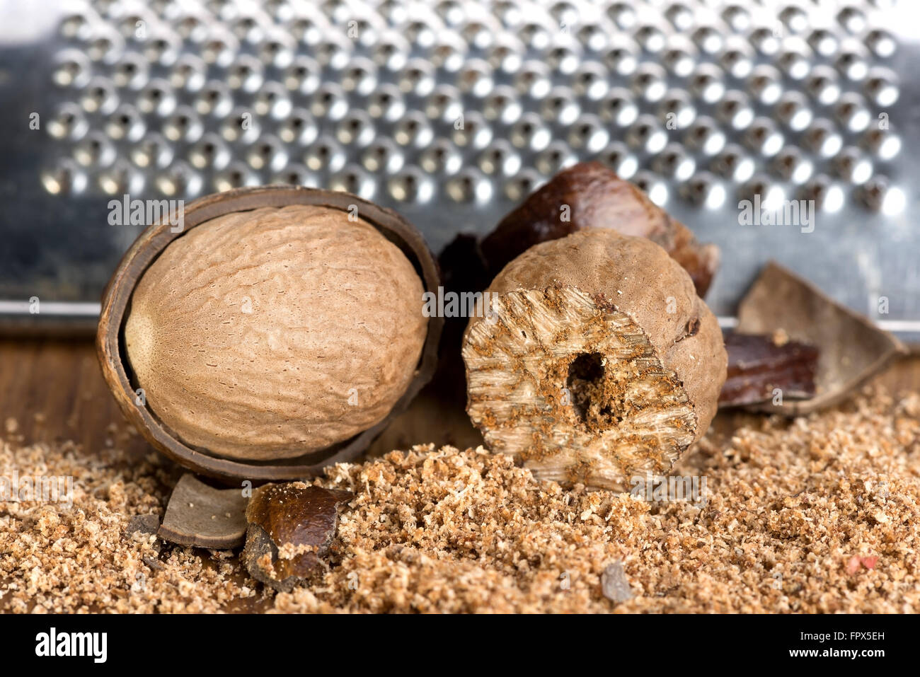 grated nutmeg and whole fruit on a wooden plate Stock Photo - Alamy