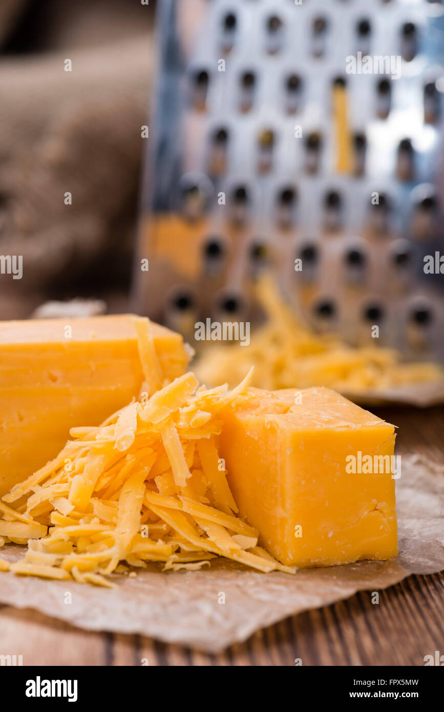 Portion of grated Cheddar Cheese on rustic wooden background Stock ...