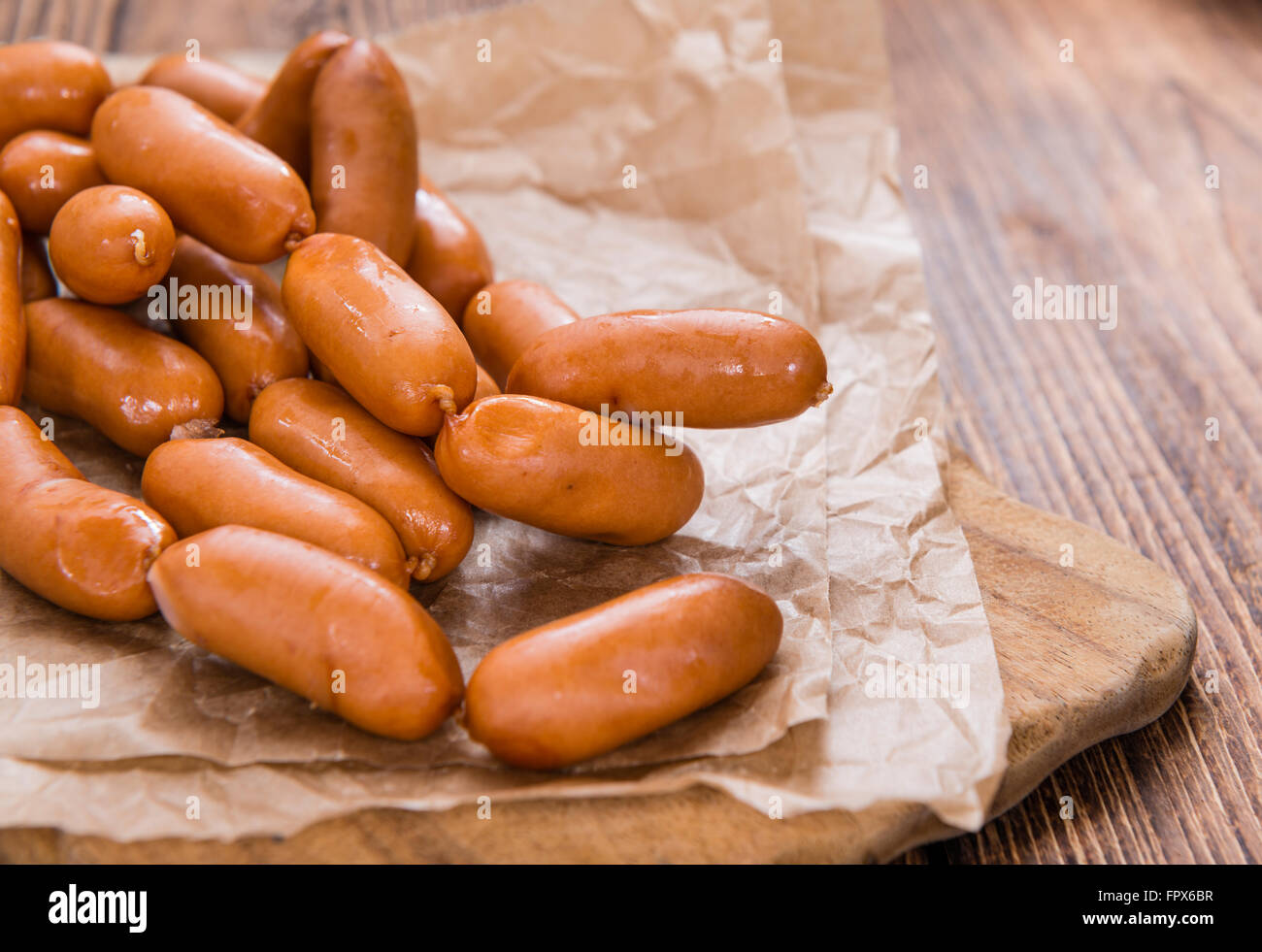 Small Sausages on an old rustic wooden background Stock Photo - Alamy