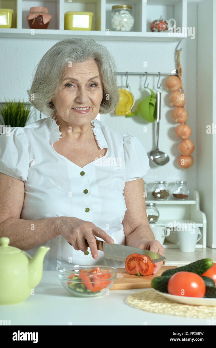 Senior woman cooking in kitchen Stock Photo - Alamy